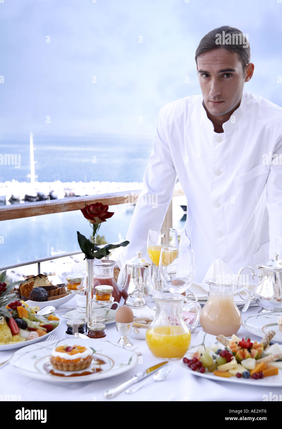 Waiter with breakfast table Stock Photo - Alamy