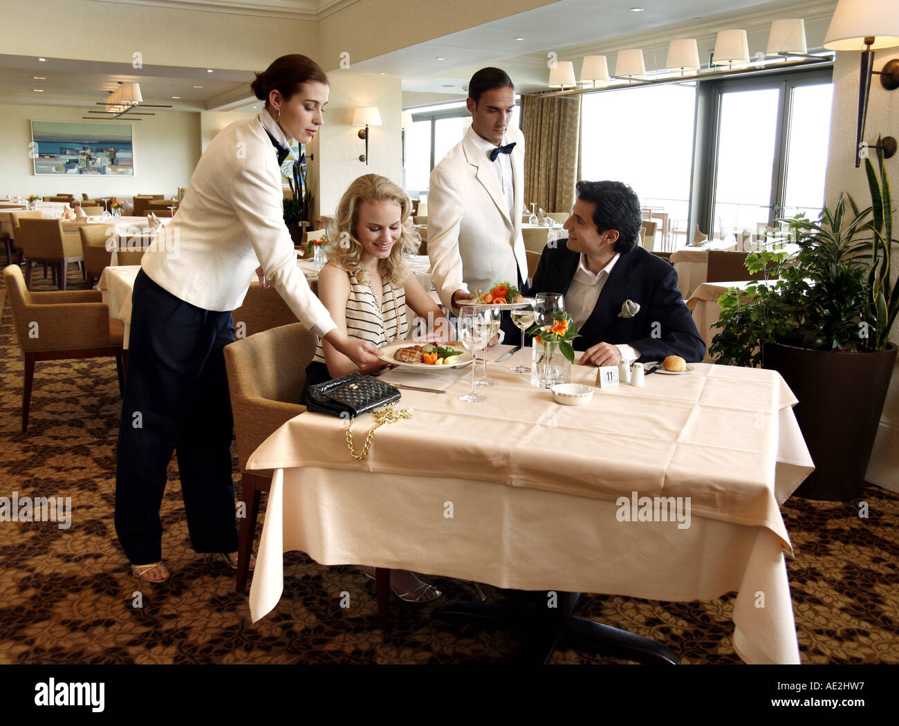 Couple being served in a restaurant Stock Photo - Alamy