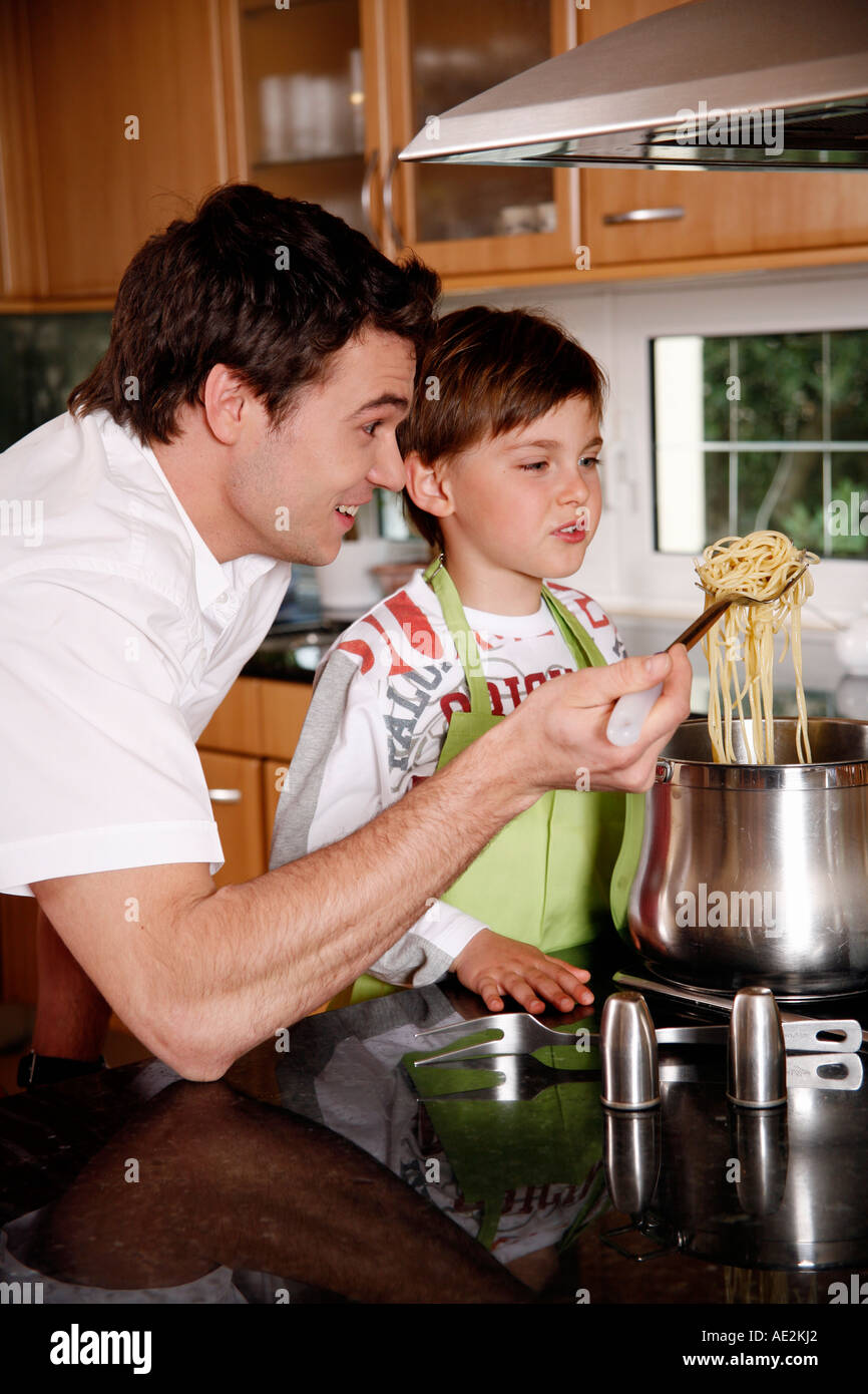 Father and son cooking spaghetti Stock Photo - Alamy