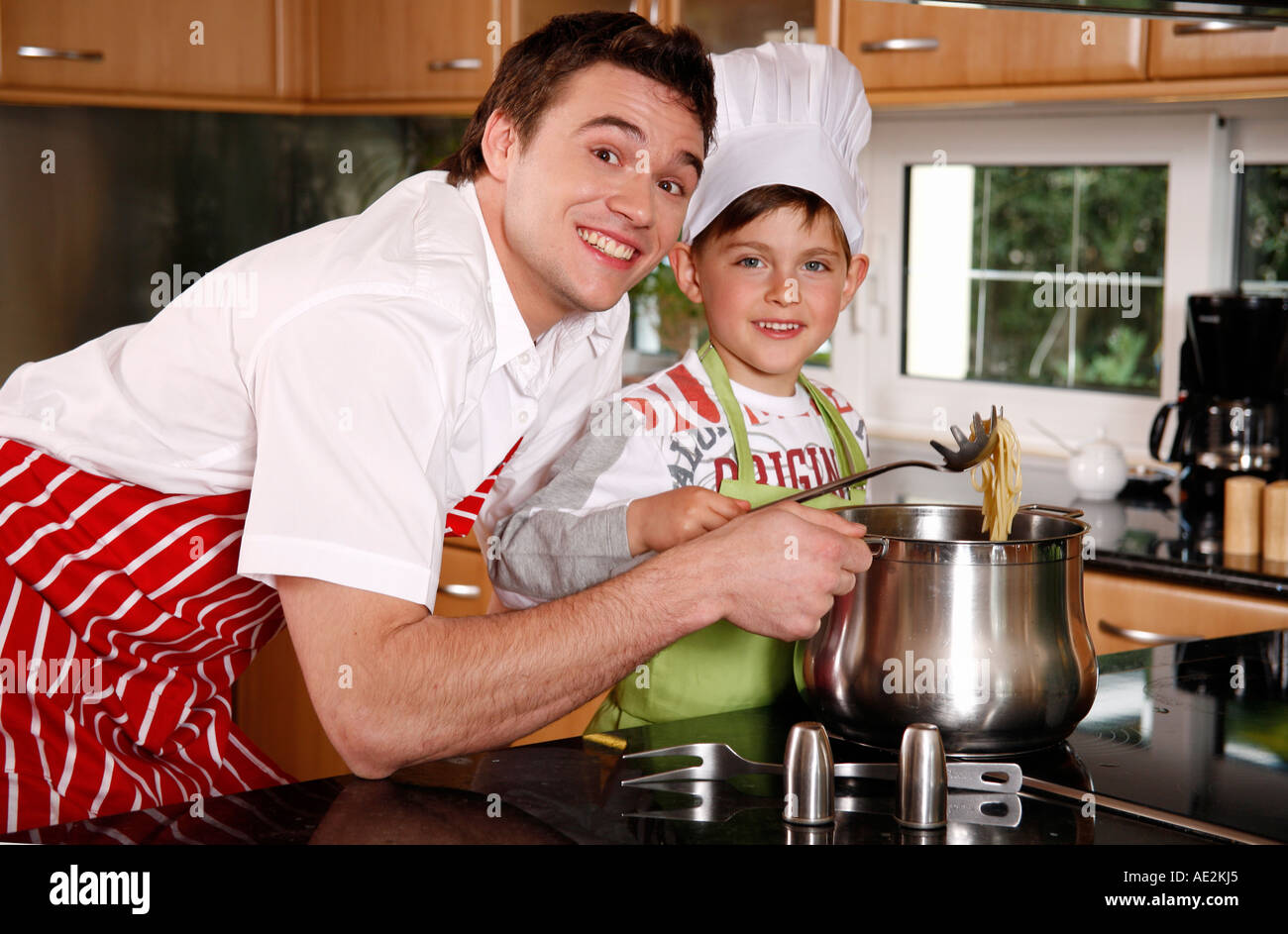 Father and son cooking spaghetti Stock Photo - Alamy