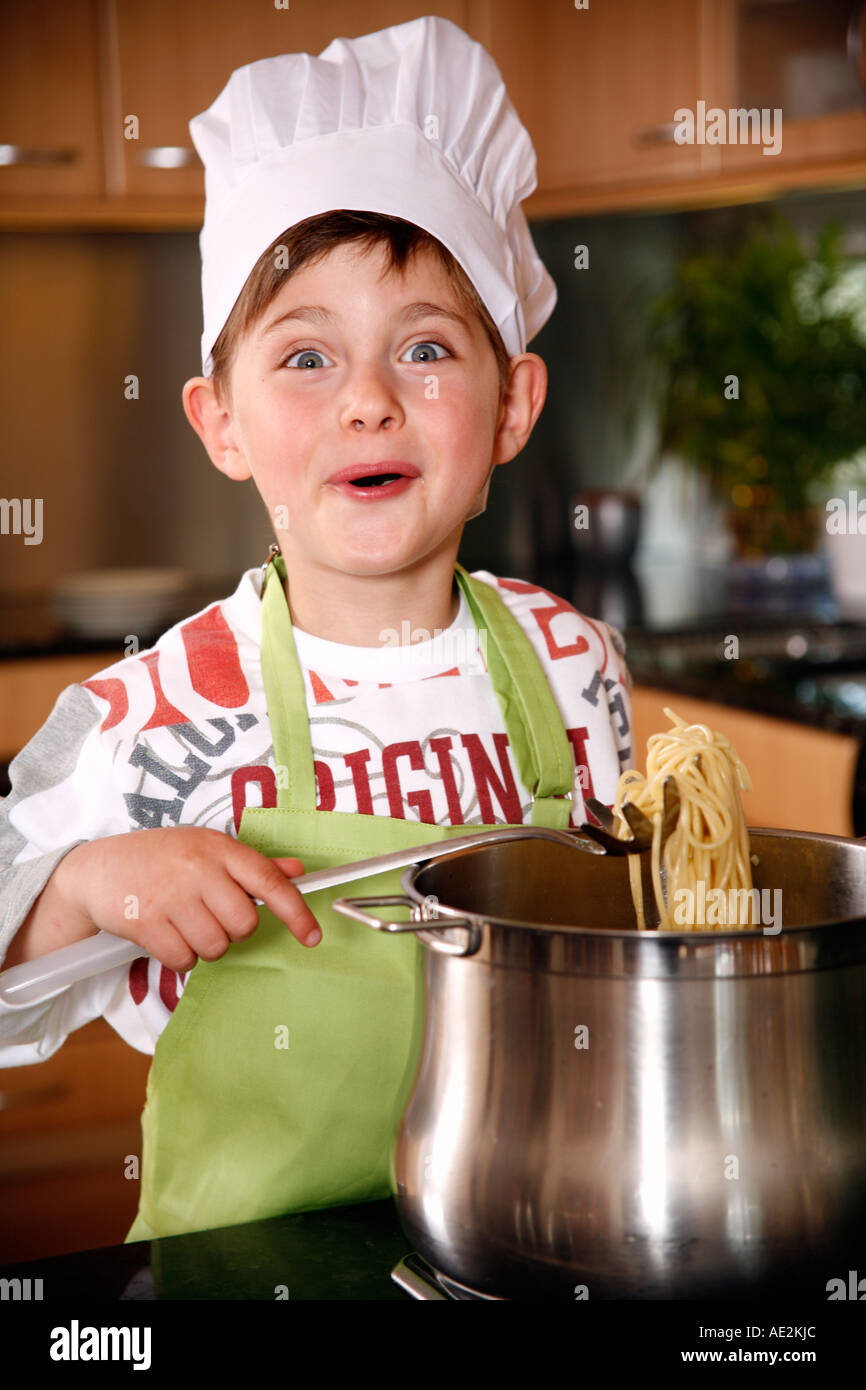 Boy cooking spaghetti Stock Photo - Alamy