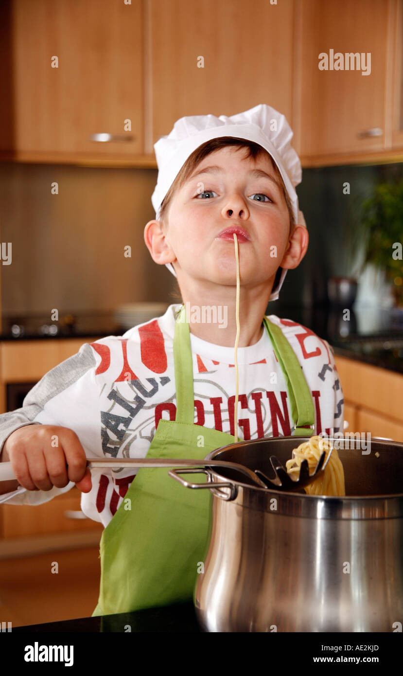 Boy cooking spaghetti Stock Photo - Alamy