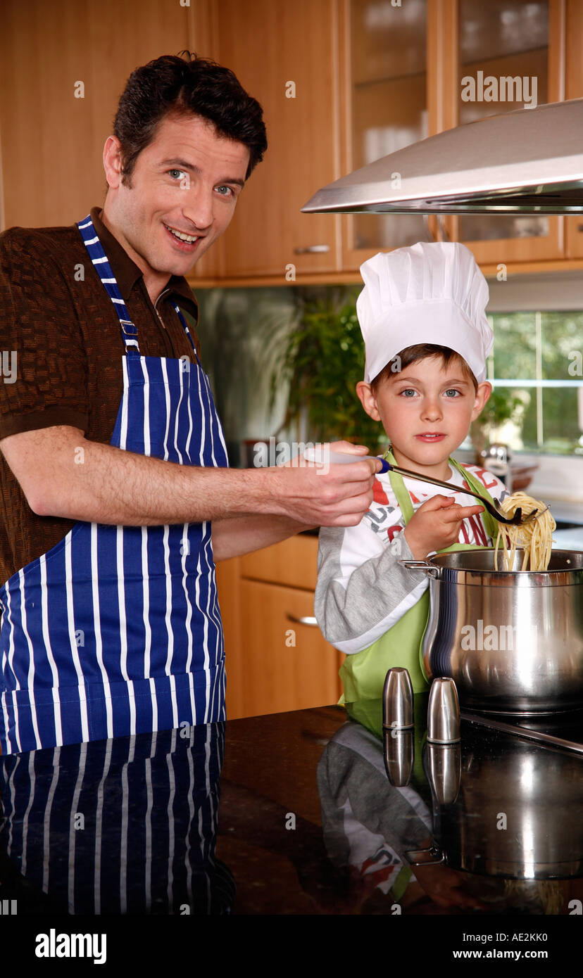 Father and son cooking spaghetti Stock Photo - Alamy