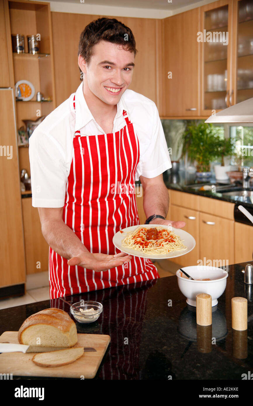Man presenting a plate of spaghetti Stock Photo - Alamy