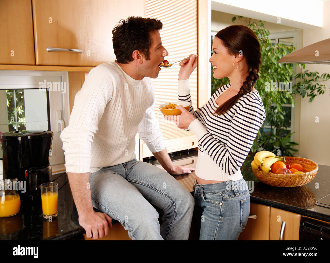 A young couple eating breakfast Stock Photo - Alamy