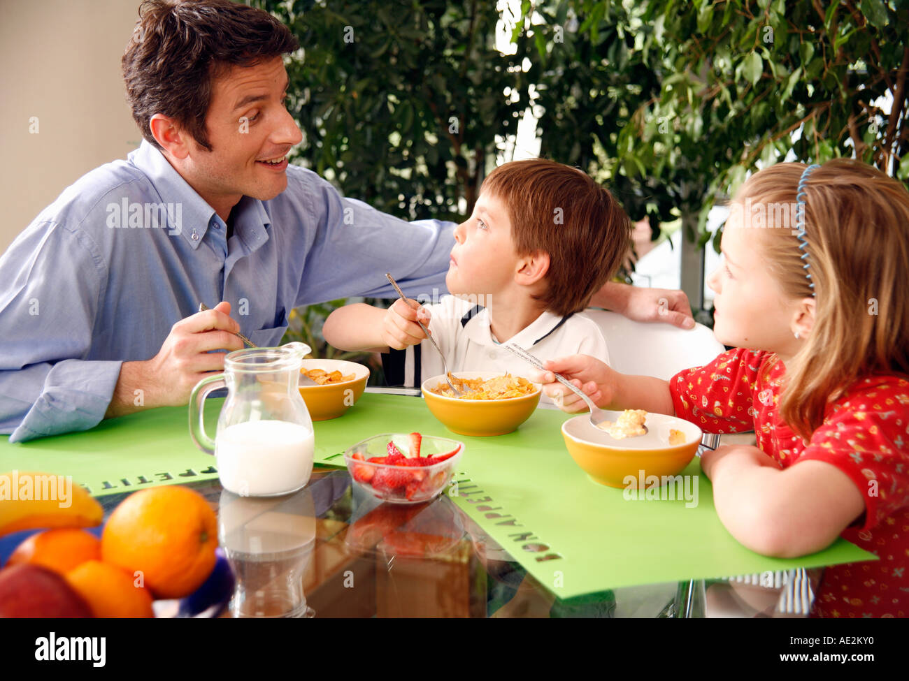 Father and children eating breakfast Stock Photo - Alamy