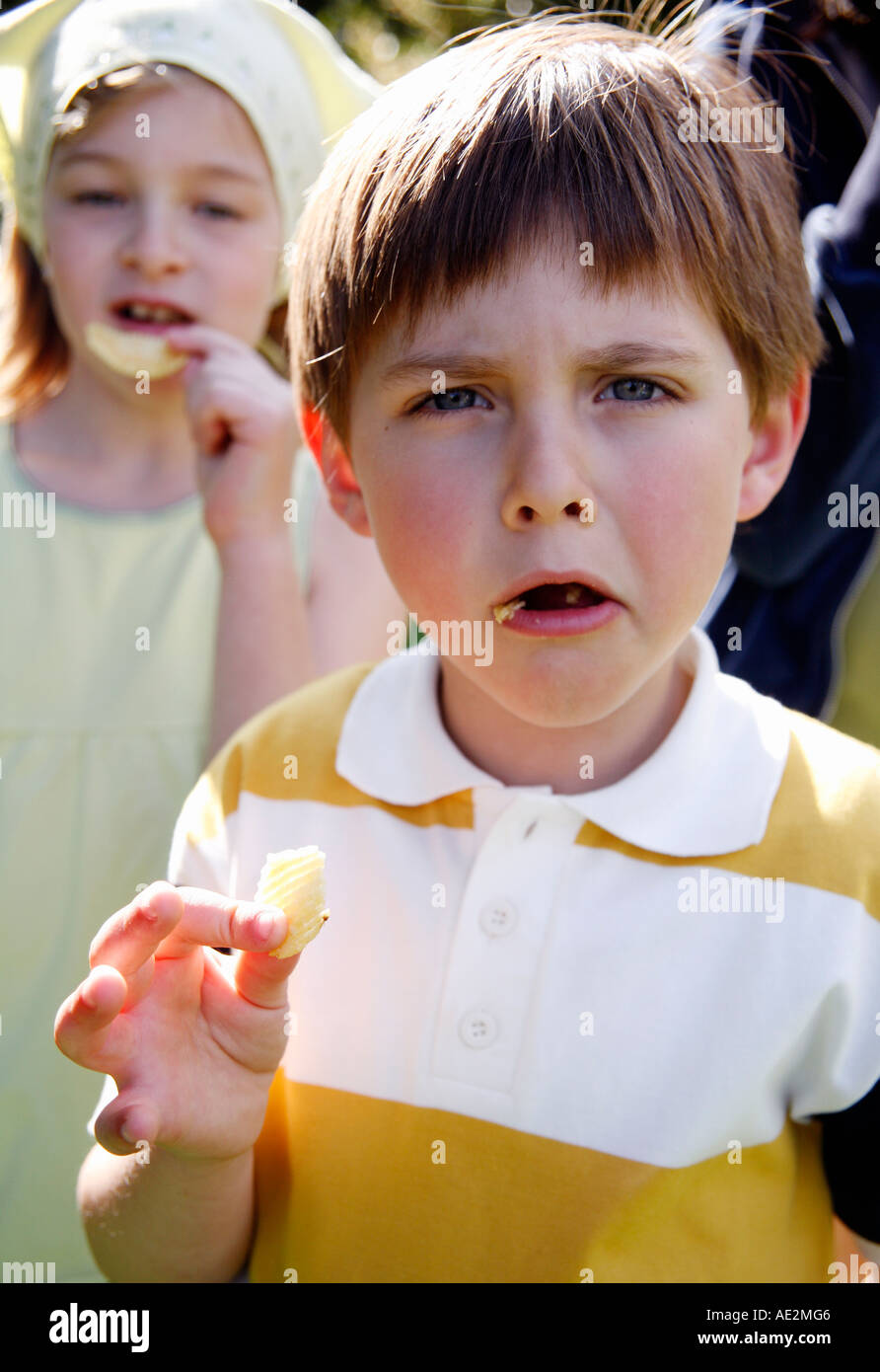 Children eating potato chips Stock Photo - Alamy