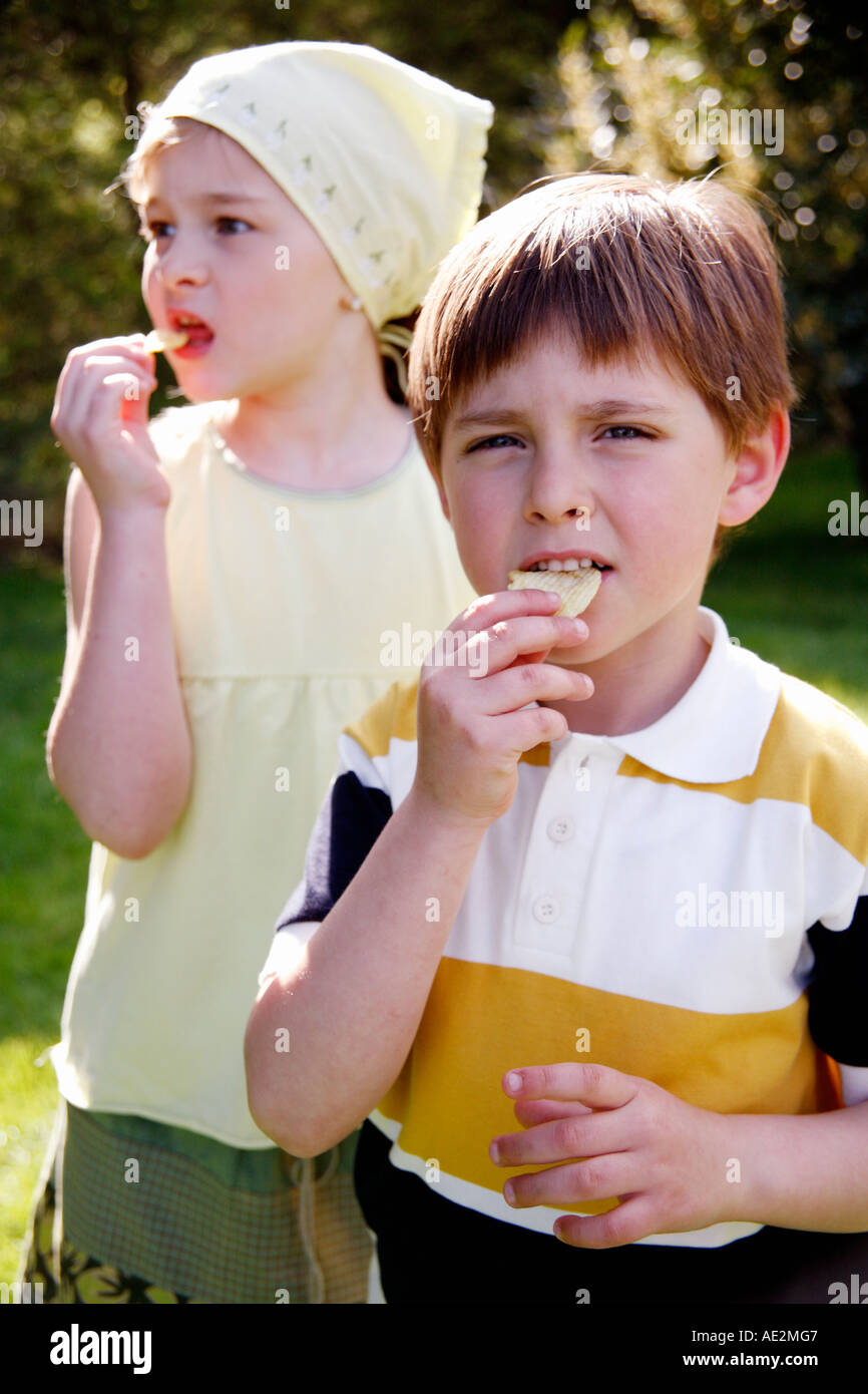 Children eating potato chips Stock Photo - Alamy