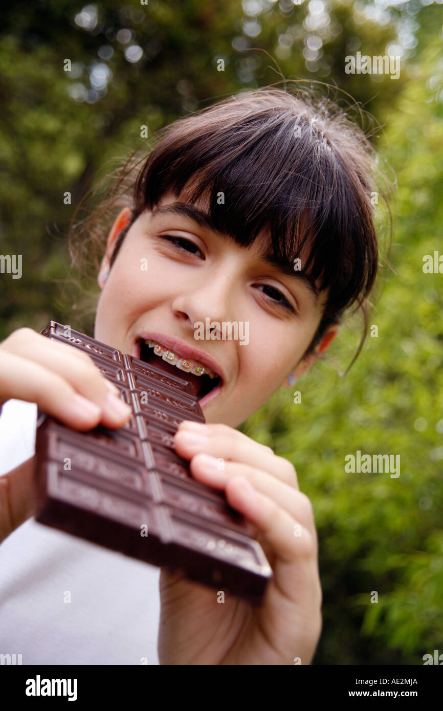 Young teenage girl eating chocolate Stock Photo - Alamy