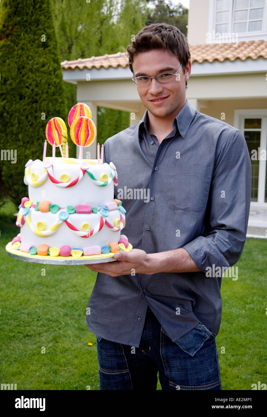 Man holding party cake Stock Photo - Alamy