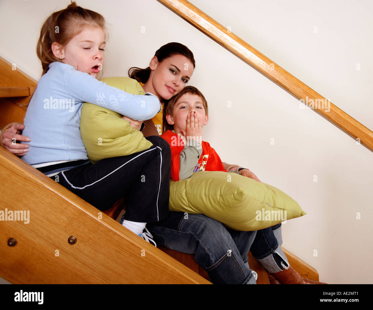 Mother with tired children on staircase Stock Photo - Alamy