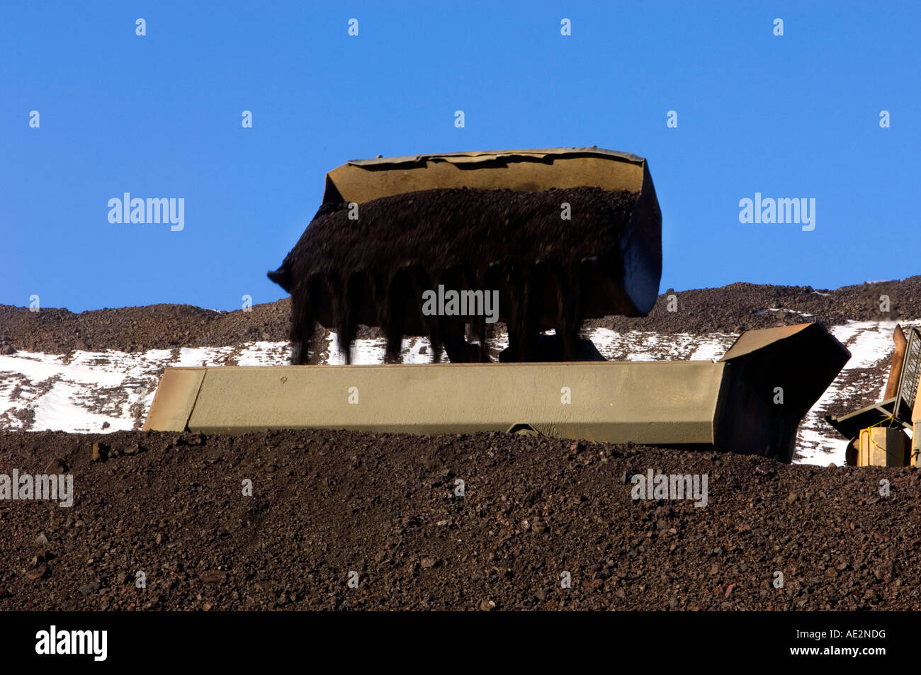 Slag dump slope stabilizing operation with truck being loaded, Greater ...