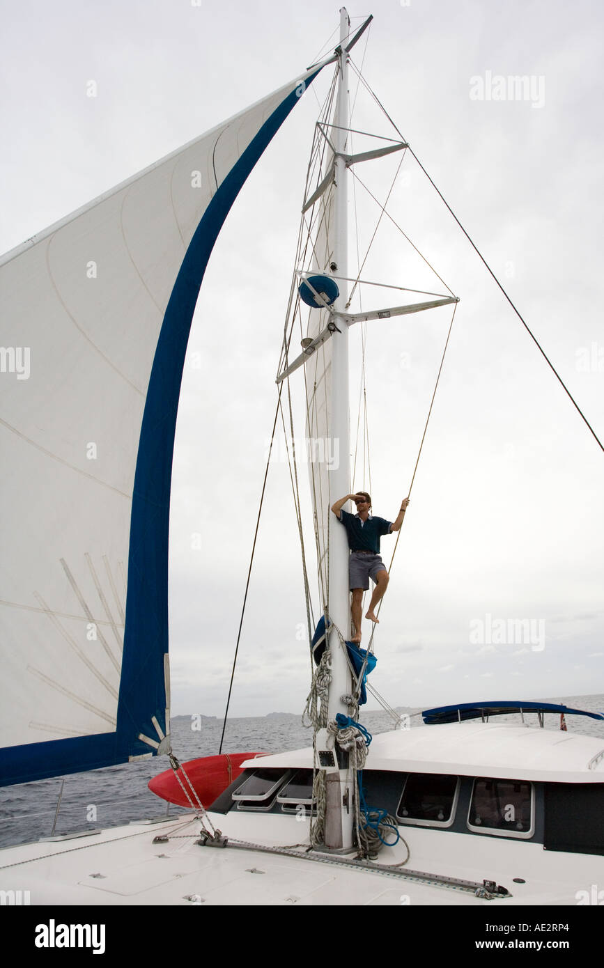 Crewman on lookout duty on a luxury catamaran in the South Pacific ...