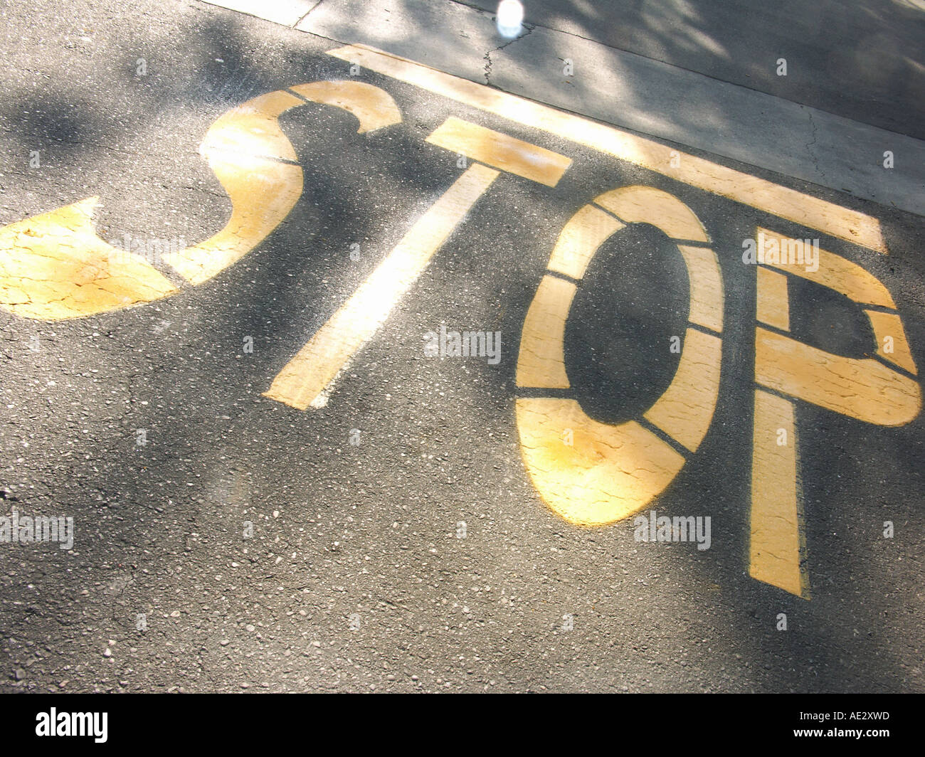 Stop sign on pavement at a parking lot exit Stock Photo - Alamy