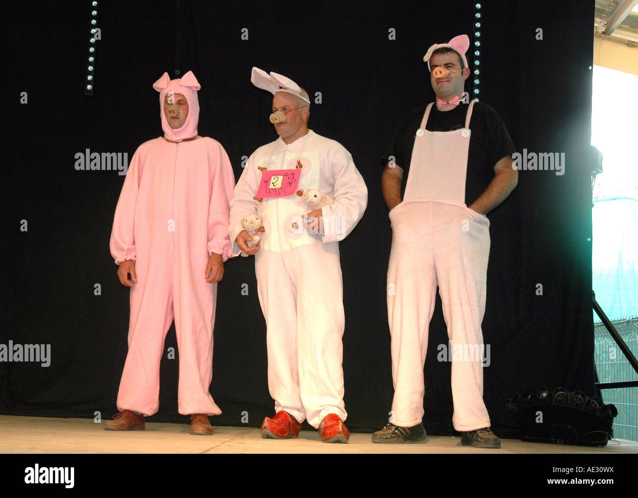 Three contestants in the annual Trie sur Baïse pig squealing ...
