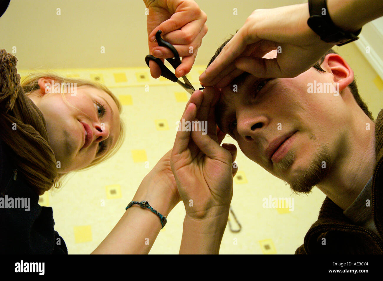Woman cutting hair her friend man Stock Photo - Alamy