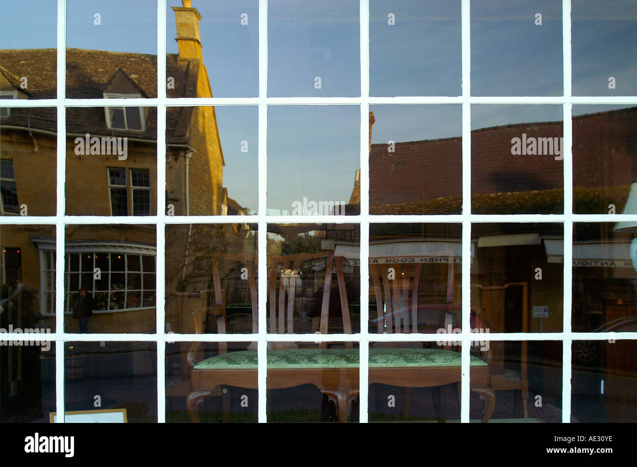 Reflection of Broadway village street in tiled window, England Stock ...