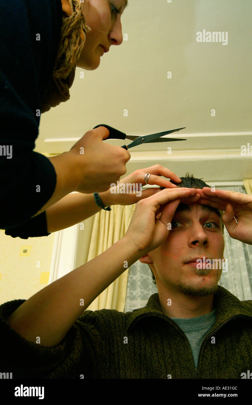 Woman cutting hair her friend man Stock Photo - Alamy