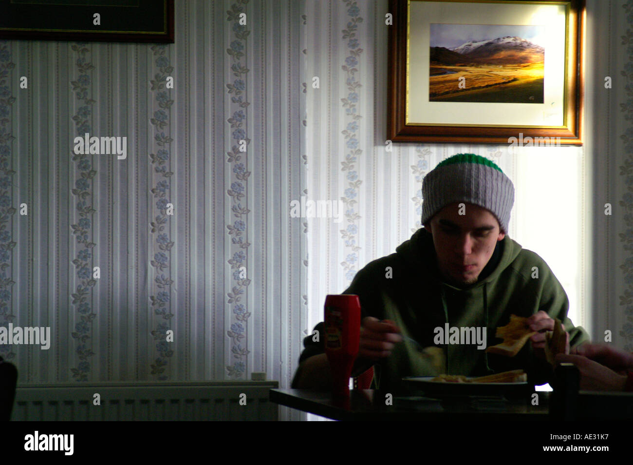 Boy eating breakfast in living room of traditional british B&B Stock ...