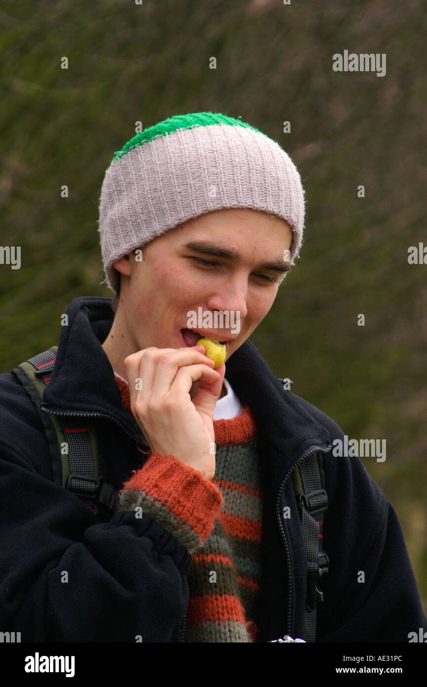 Man eating wild apple, funny faces Stock Photo - Alamy