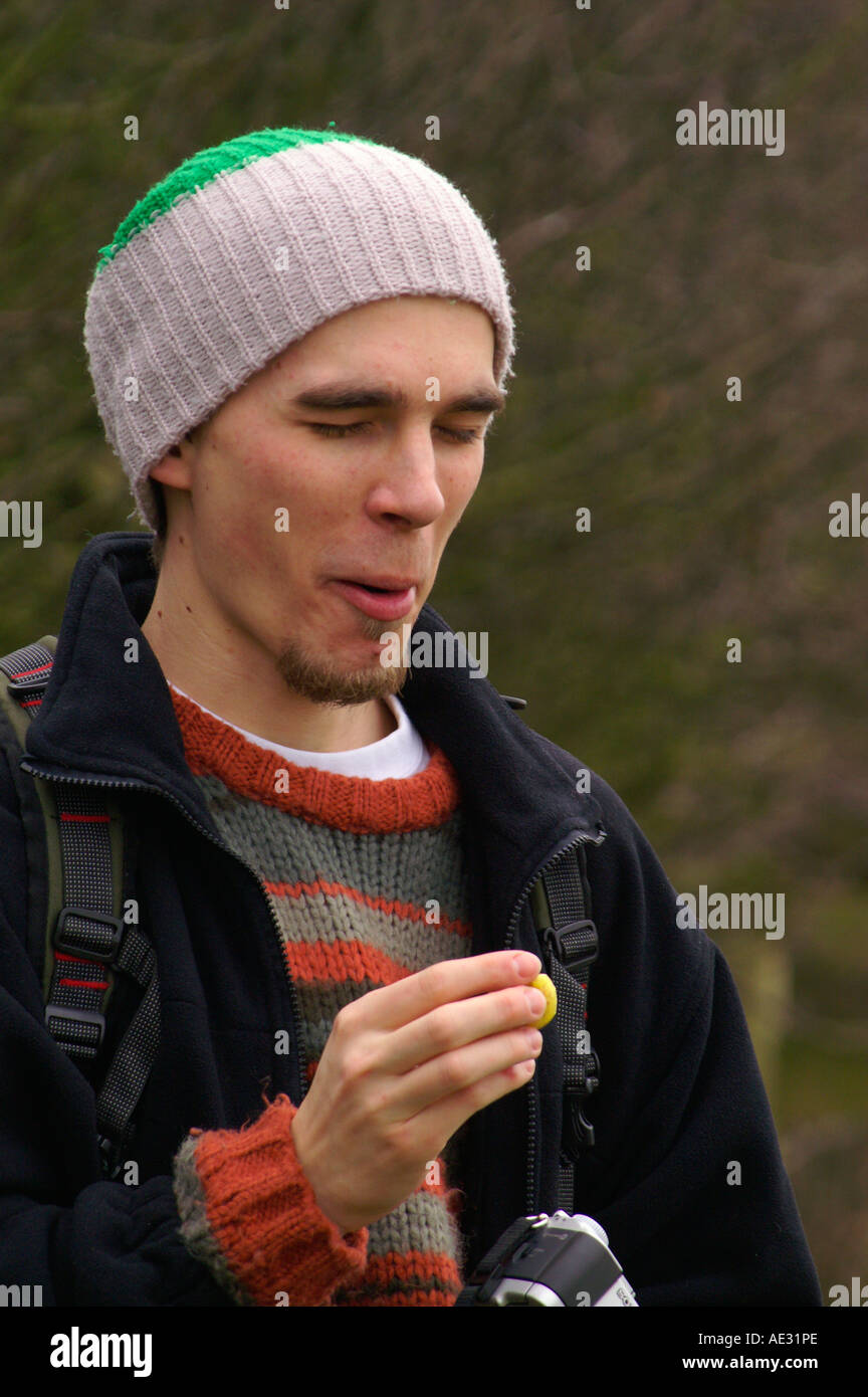 Man eating wild apple, funny faces Stock Photo - Alamy