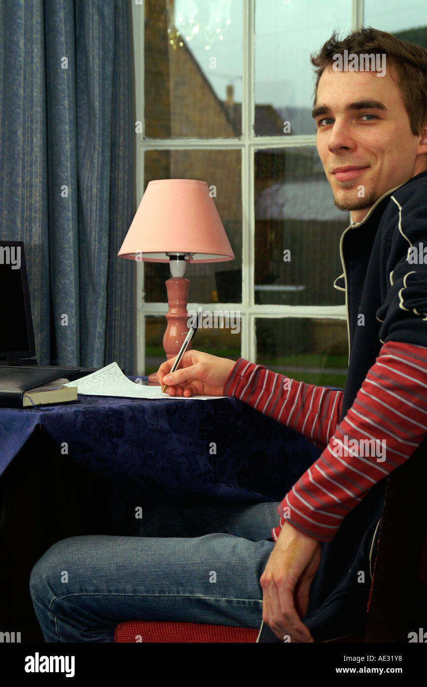 Man writing a letter in a livingroom by the window Stock Photo - Alamy