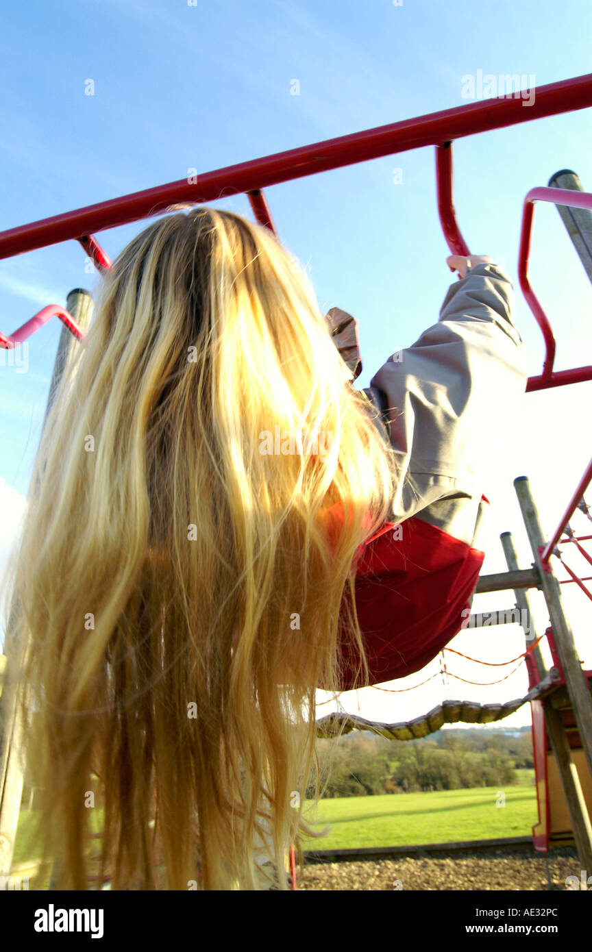 Blonde woman in 20s hanging, children playground outdoors Stock Photo ...
