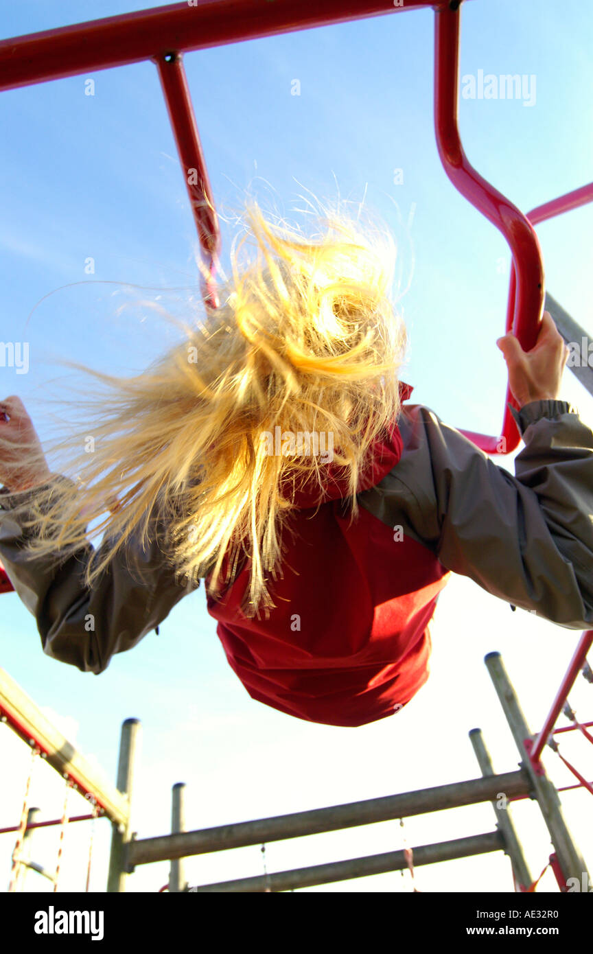 Blonde woman in 20s hanging, children playground outdoors Stock Photo ...