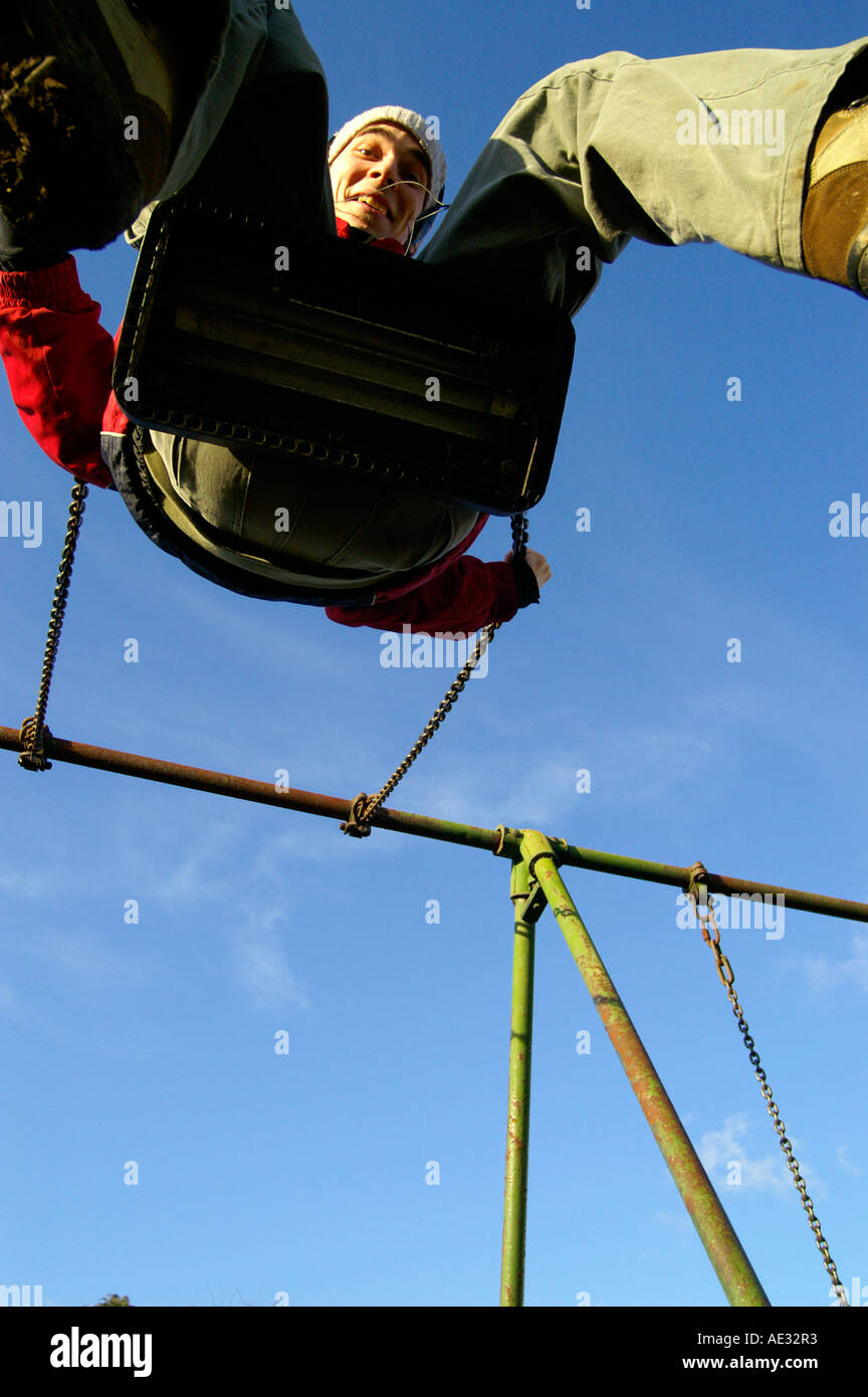 Man in 20s swinging on a swing, children playground outdoors Stock ...