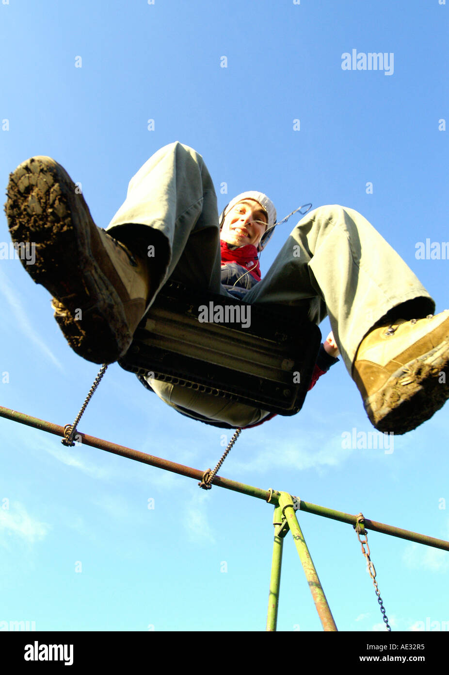 Man in 20s swinging on a swing, children playground outdoors Stock ...