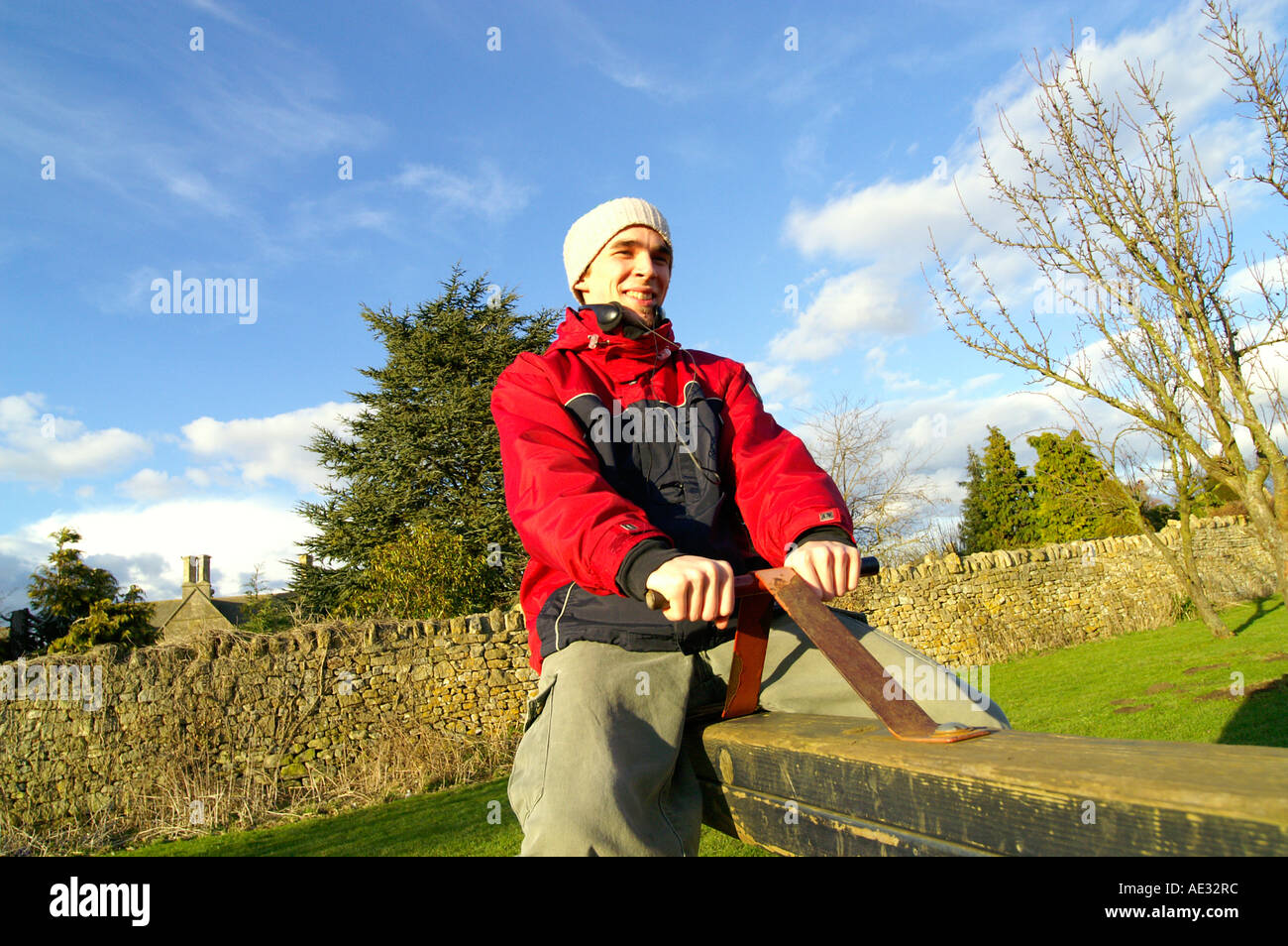 Man in 20s swinging on a seesaw, children playground outdoors Stock ...