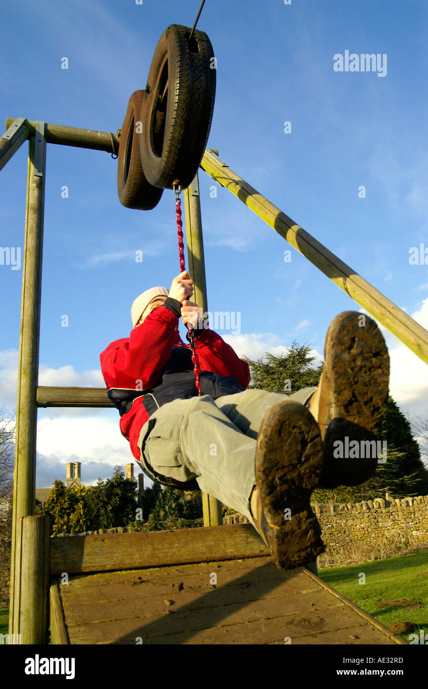 Man in 20s riding ropeway children playground outdoors Stock Photo - Alamy