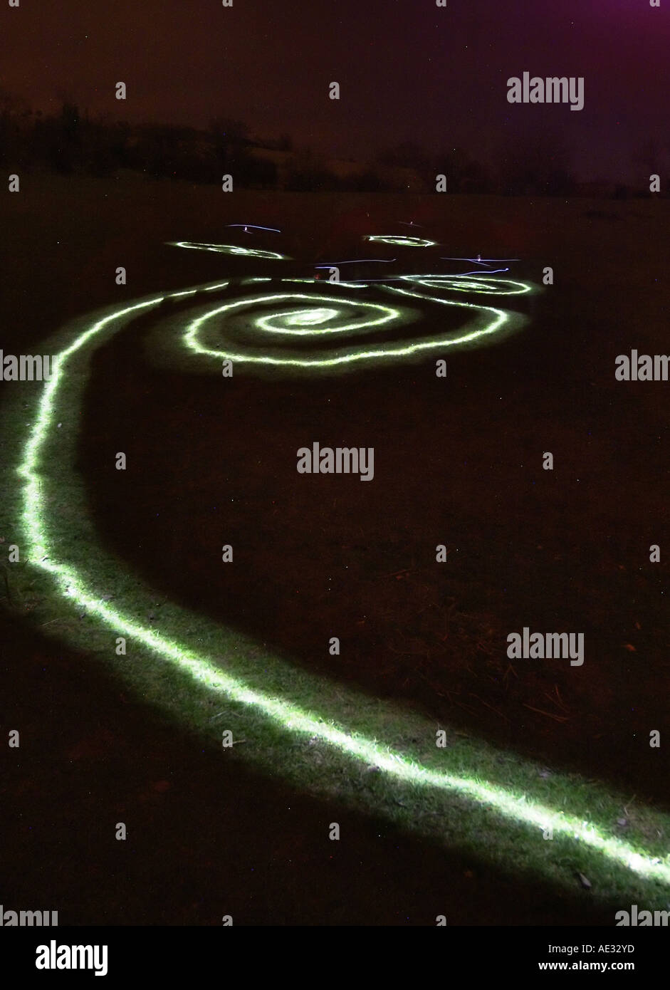 Concept - finding, dark meadow with light spiral Stock Photo - Alamy