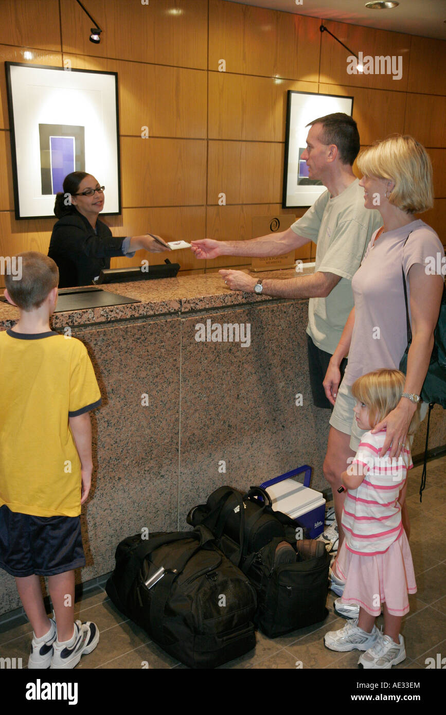 Family at a hotel reservation desk hi-res stock photography and images ...
