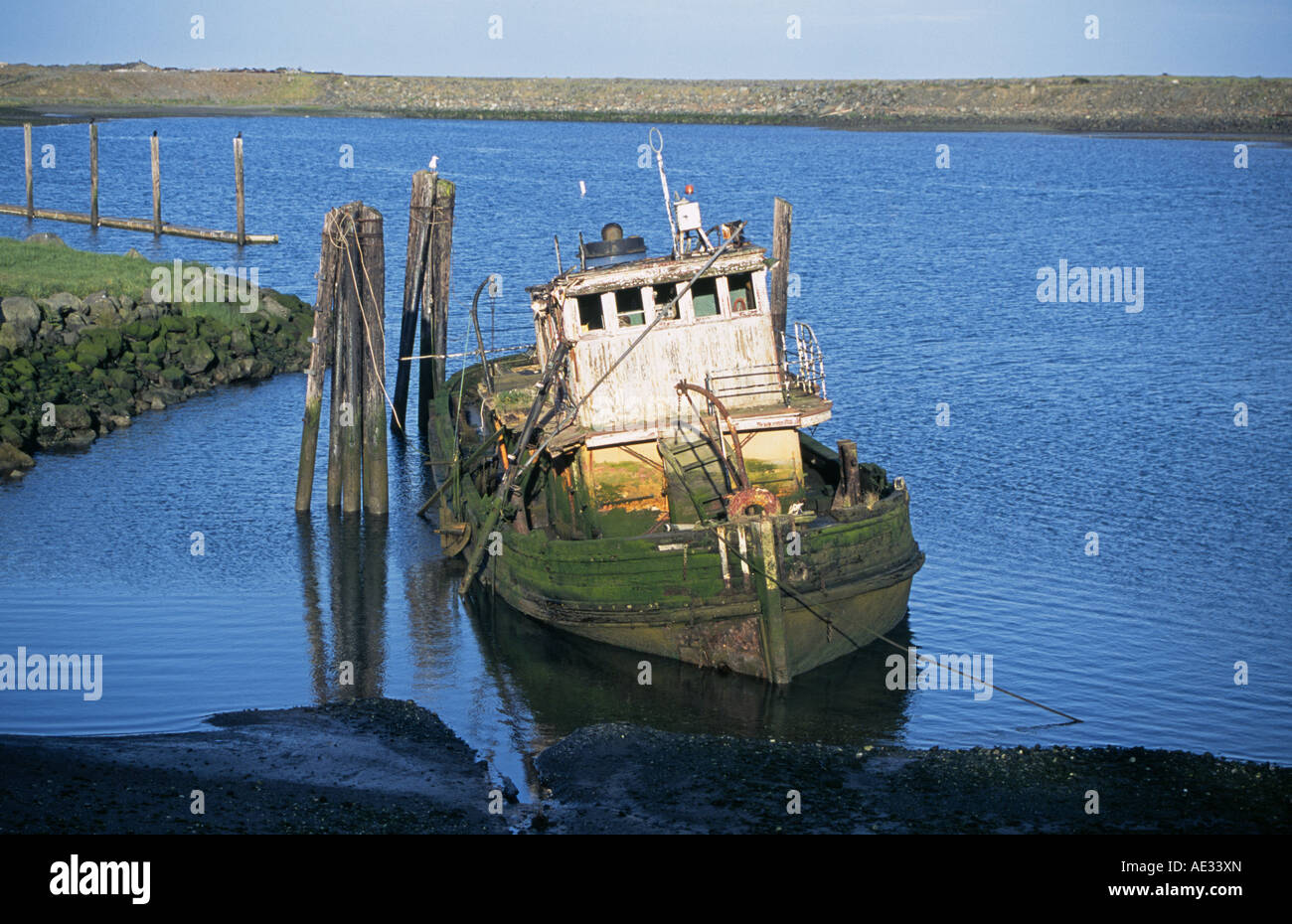 The wreck of an old fishing boat in the Gold Beach Harbor near the ...
