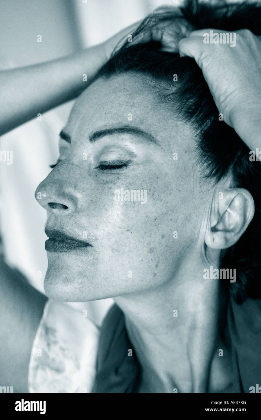 woman stretches her facial skin by gently pulling her hair Stock Photo ...