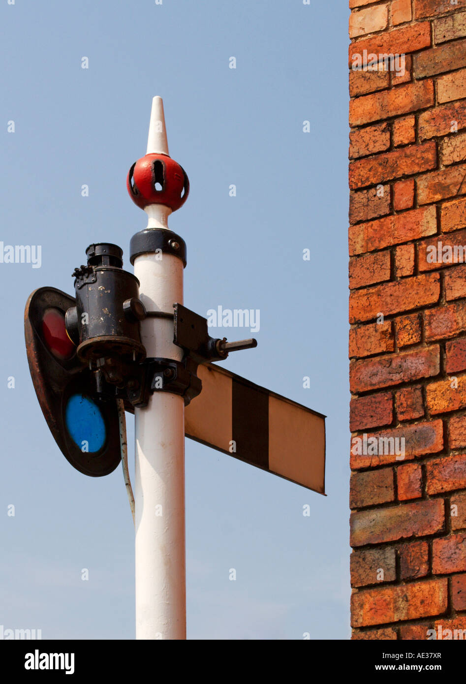 A train Signal next to a red brick wall Stock Photo - Alamy