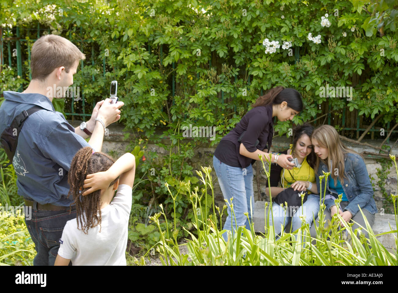 two groups of children taking pictures with mobile phone digital ...