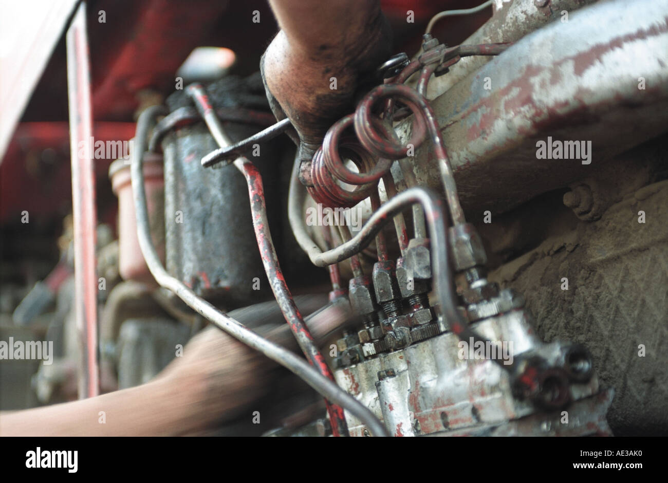 Mechanical engineer repairing tractor engine. Altai. Siberia. Russia ...