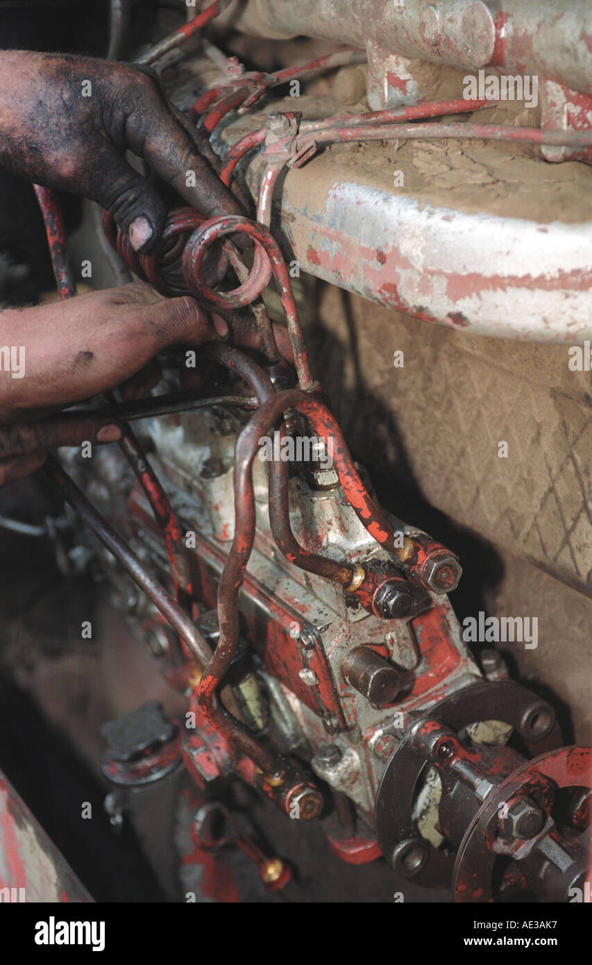 Mechanical engineer repairing tractor engine. Altai. Siberia. Russia ...