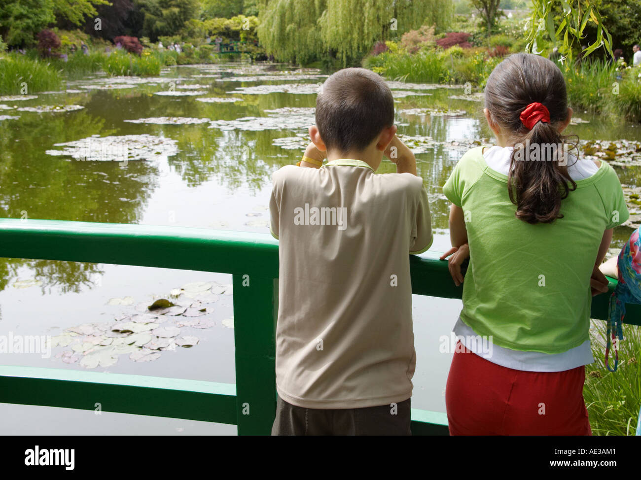 two children visitors in the water garden at Monets garden at Giverny ...