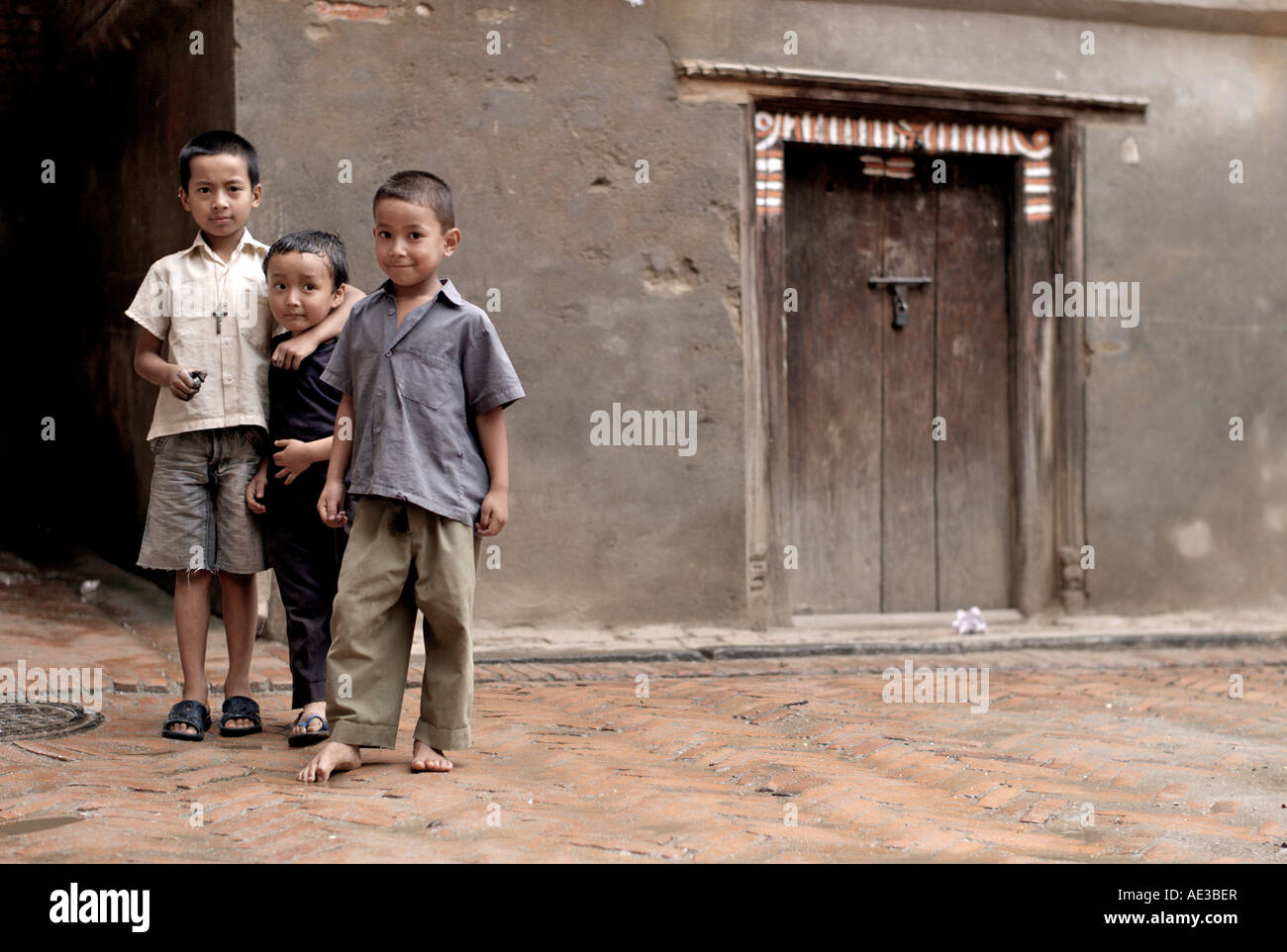 Three boys playing in street Nepal Stock Photo - Alamy