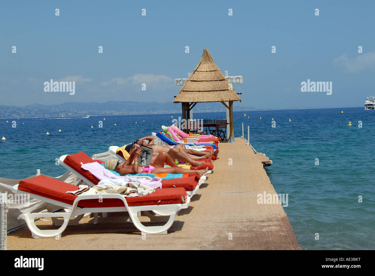 Sunbathers on a Pier Stock Photo - Alamy
