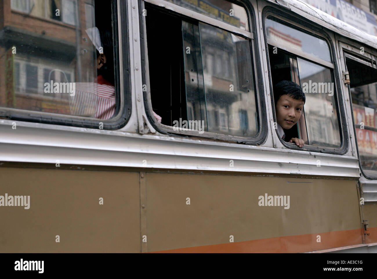 Boy looking out of bus window Stock Photo - Alamy