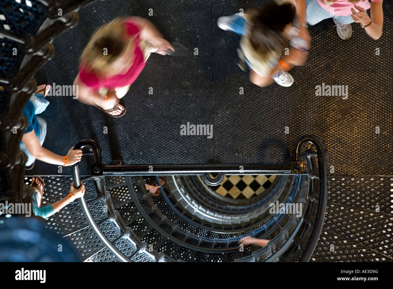 People climbing spiral stair way inside lighthouse at St. Augustine ...