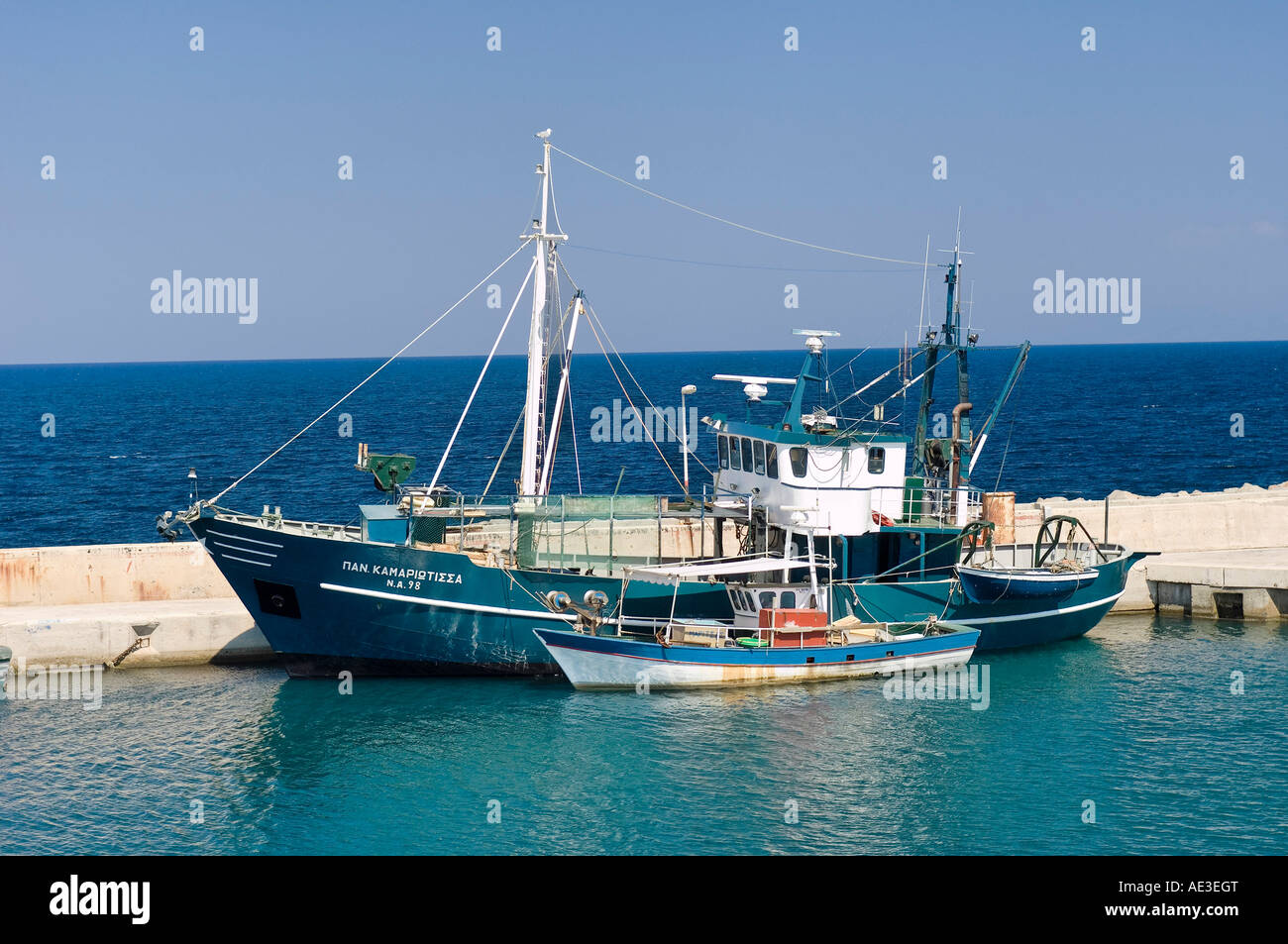 A blue and a white boat in Kamariotisa port at Samothraki Island in ...