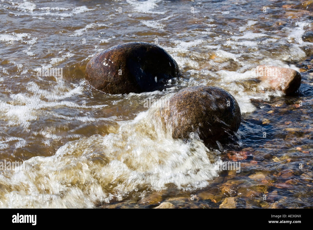 wave hitting rocks on shore Stock Photo - Alamy