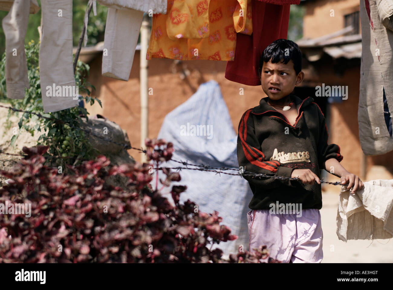 Boy standing by the washing Stock Photo - Alamy