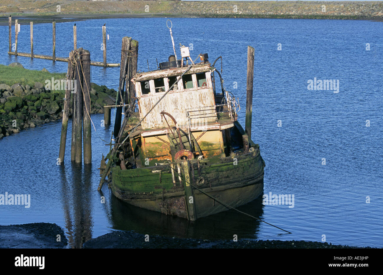 The wreck of an old fishing boat in the Gold Beach Harbor near the ...