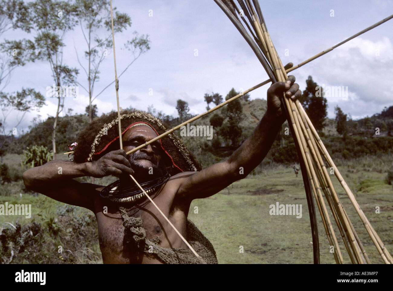 Huli man firing arrow Western Highlands Papua New Guinea Stock Photo ...